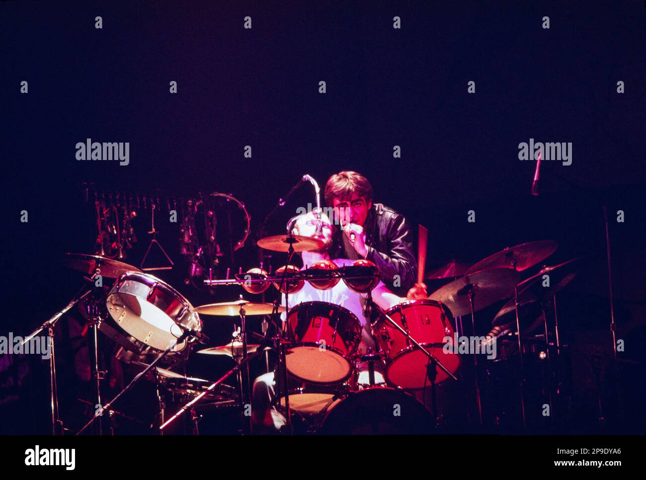 Phil Collins and Peter Gabriel of Genesis share vocals in concert Stock ...