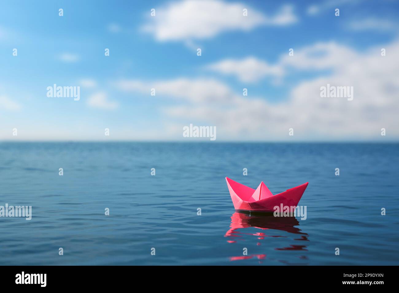 Pink paper boat floating on calm sea. Space for text Stock Photo - Alamy