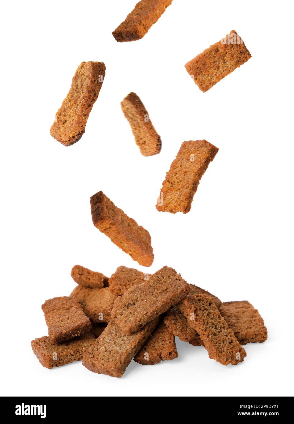 Delicious crispy rusks falling into pile on white background Stock ...