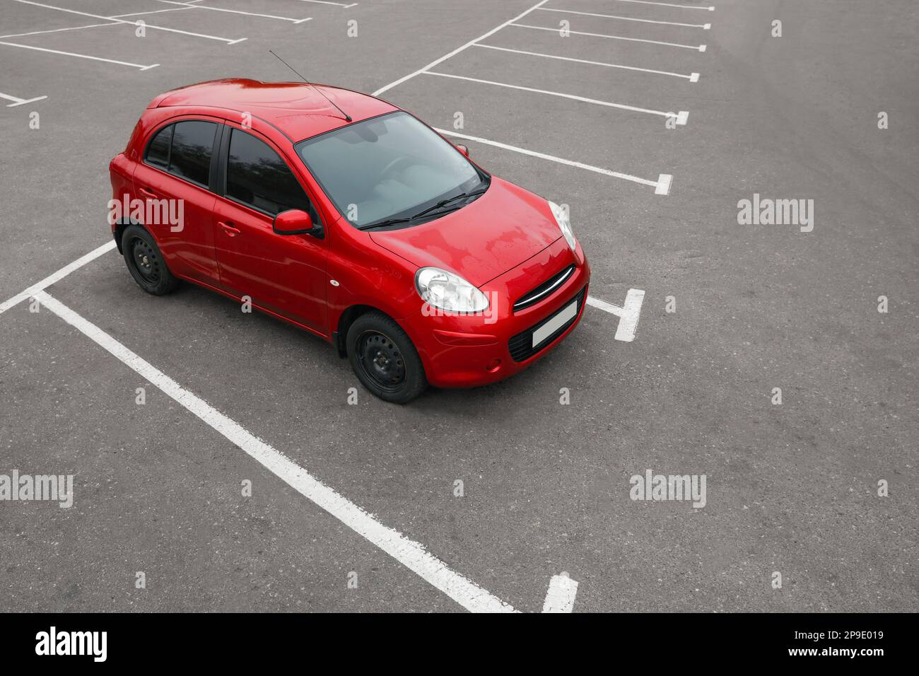 Modern red car on parking lot outdoors Stock Photo - Alamy