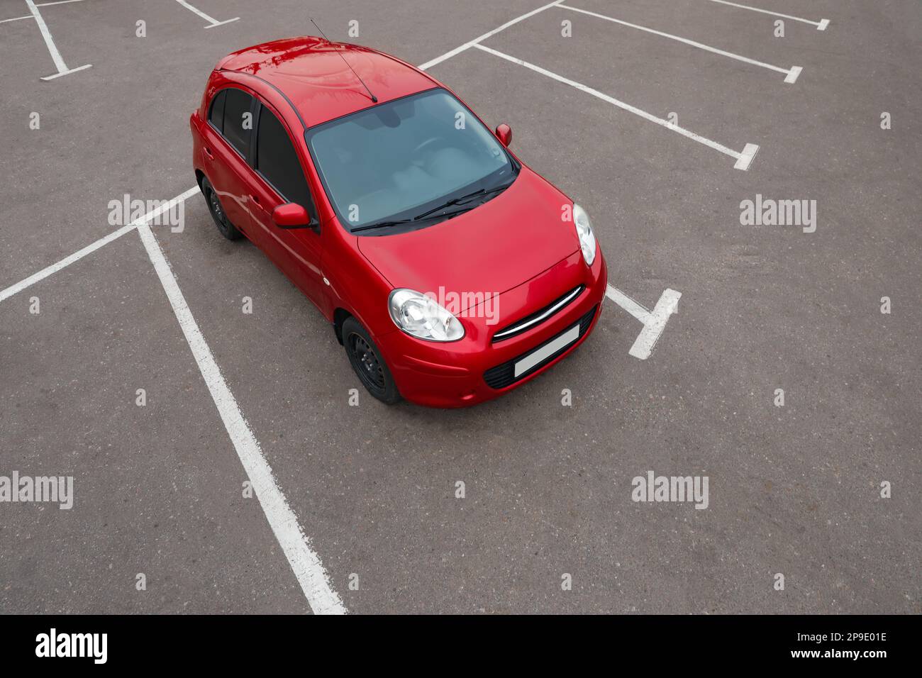 Modern red car on parking lot outdoors Stock Photo - Alamy