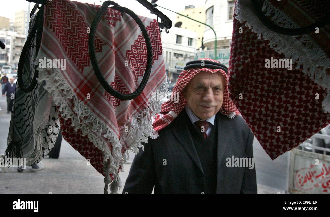 A man wearing a traditional head cover, or kofiyya, walks on Wednesday ...