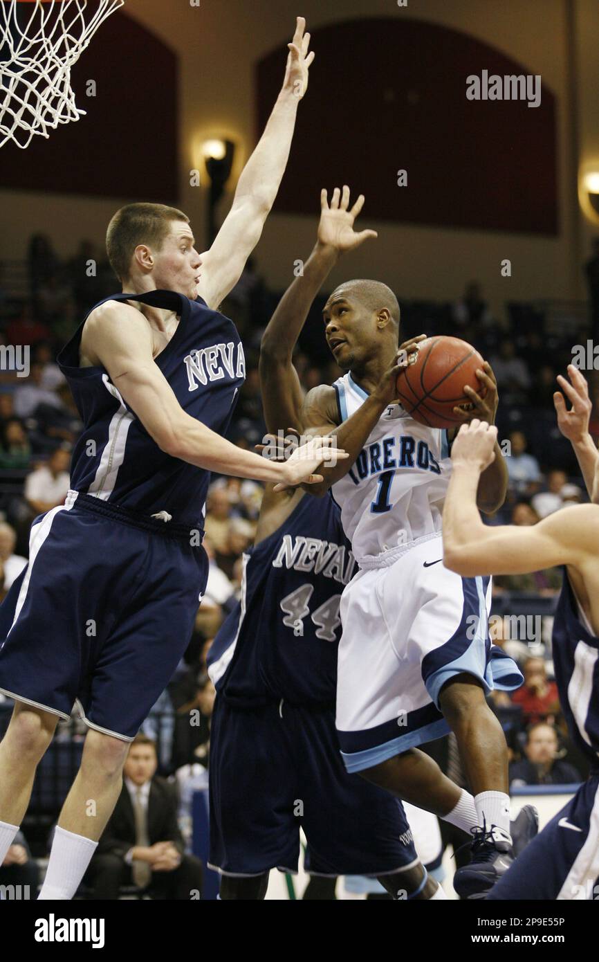 San Diego's Brandon Johnson, right, shoots over the block of Nevada's ...