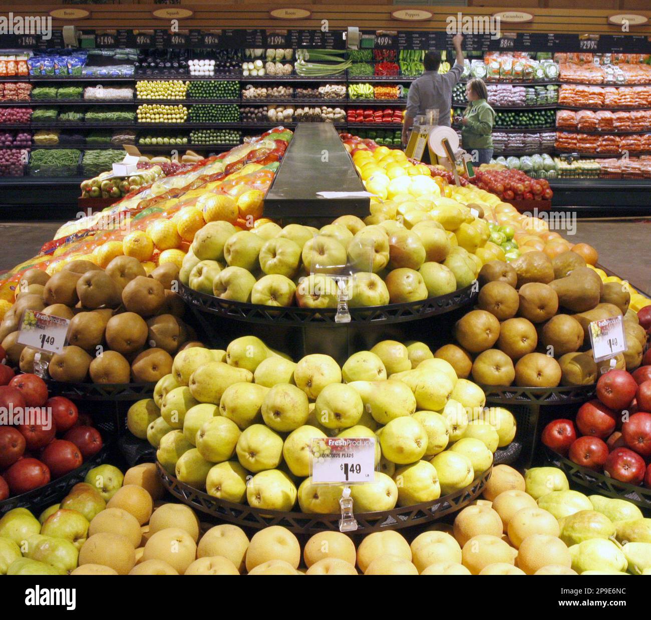 Vendors arrange fresh fruits and vegetables inside Kroger's Fresh Fare ...