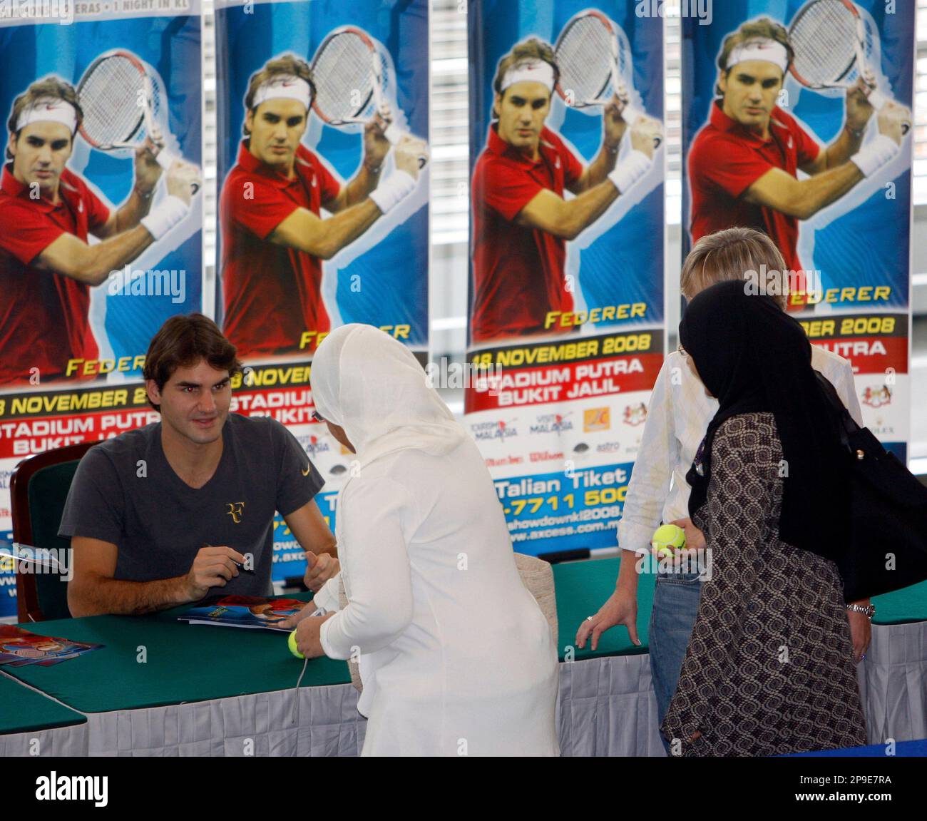 Roger Federer of Switzerland reacts as he meets the fans in Kuala ...