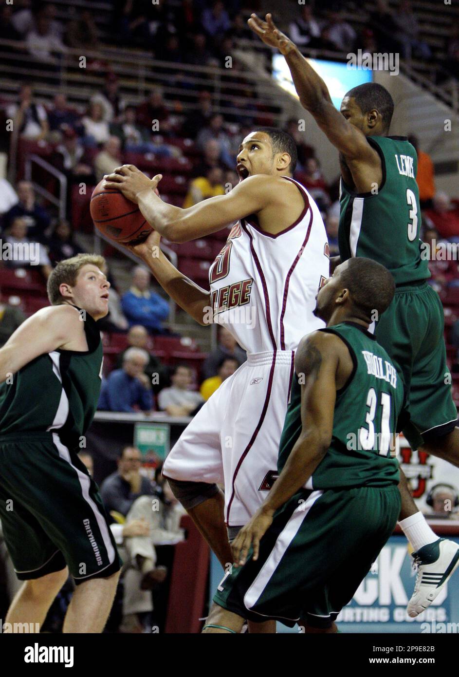 Boston College guard Dallas Elmore, center, is surrounded by Loyola ...