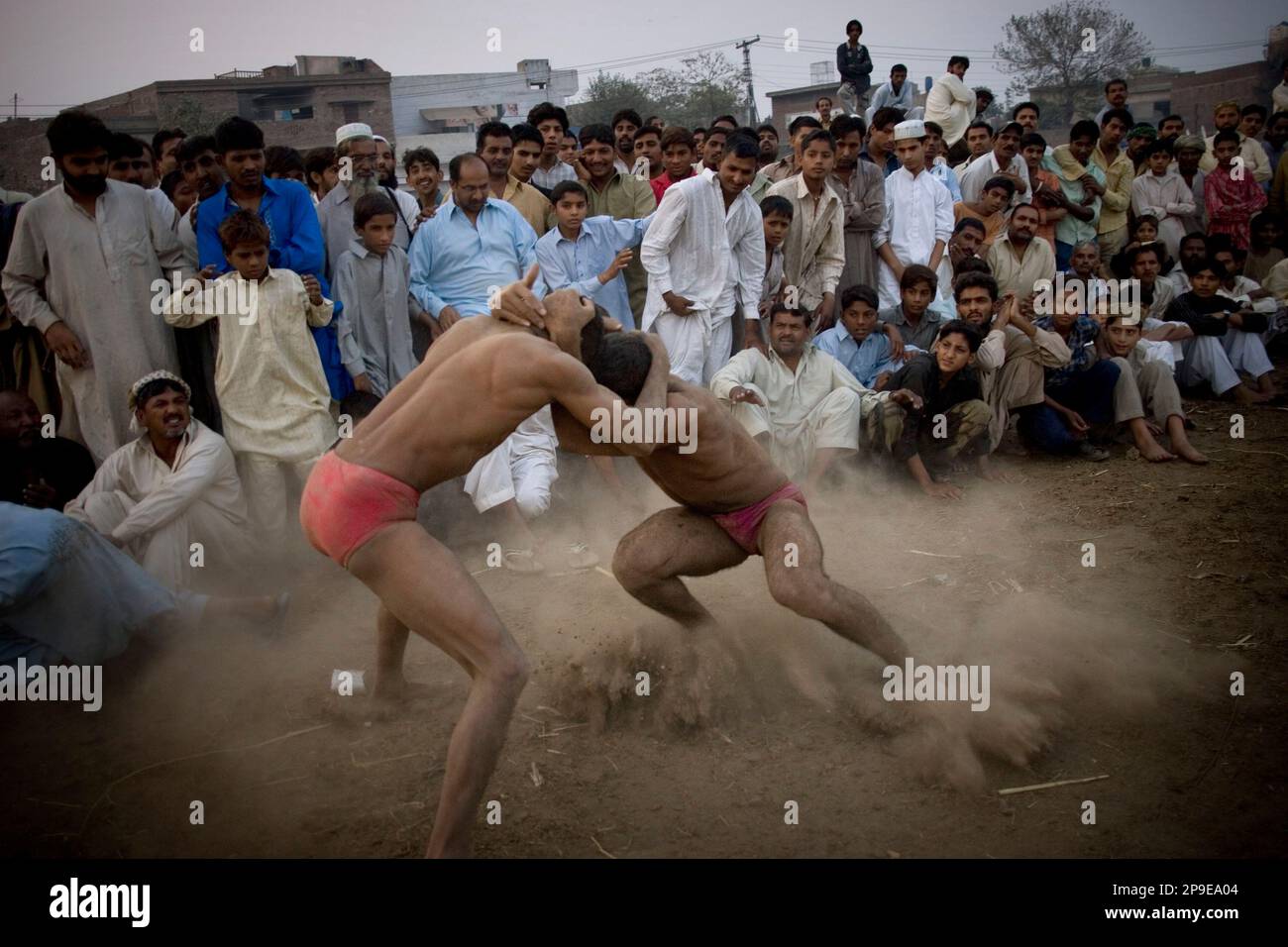 Pakistani wrestlers fight during a local competition in Lahore ...