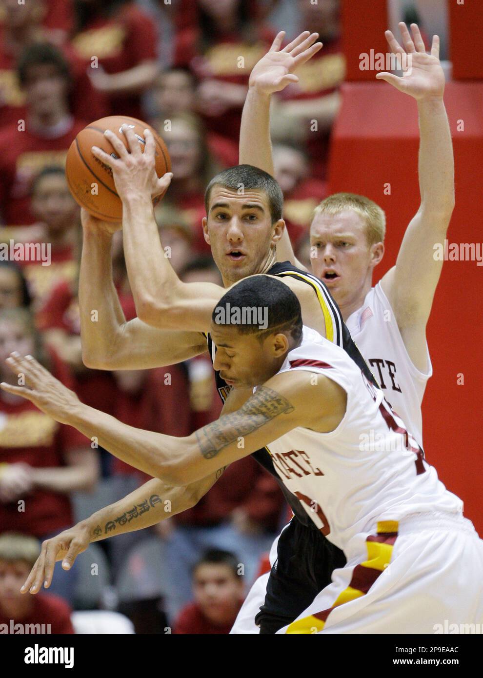 Wisconsin Milwaukee's Tone Boyle, center, looks to pass between Iowa ...