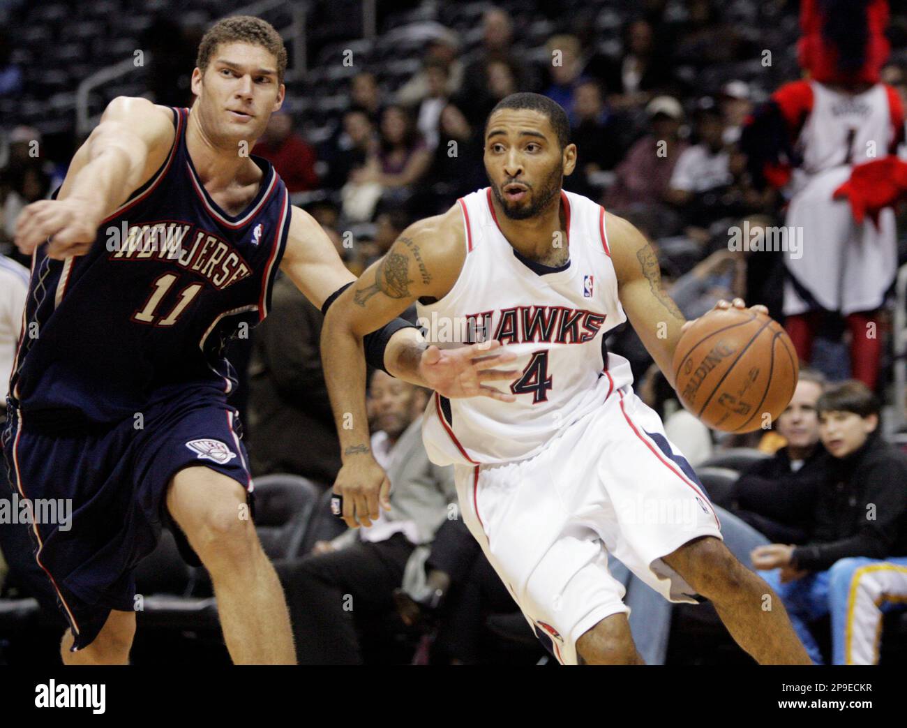 Atlanta Hawks guard Acie Law (4) tries to get by New Jersey Nets center ...