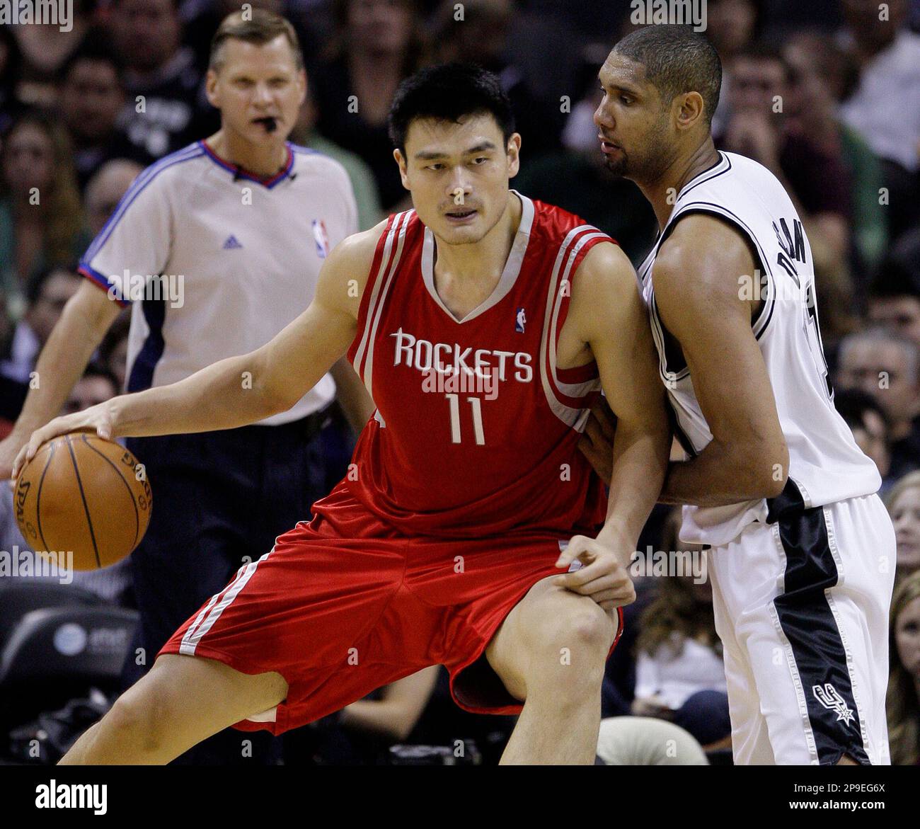 Houston Rockets center Yao Ming (11), of China, is defended by San ...
