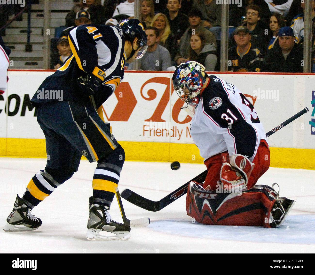 Columbus Blue Jackets goalie Pascal Leclaire, right, makes a save on ...