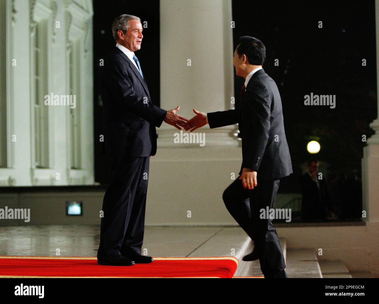 U.S. President George W. Bush greets President Lee Myung-bak of South ...
