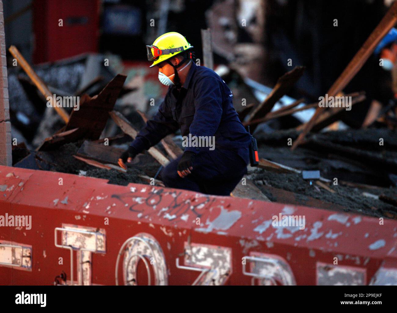Firefighters search through the rubble of a restaurant/bar that ...