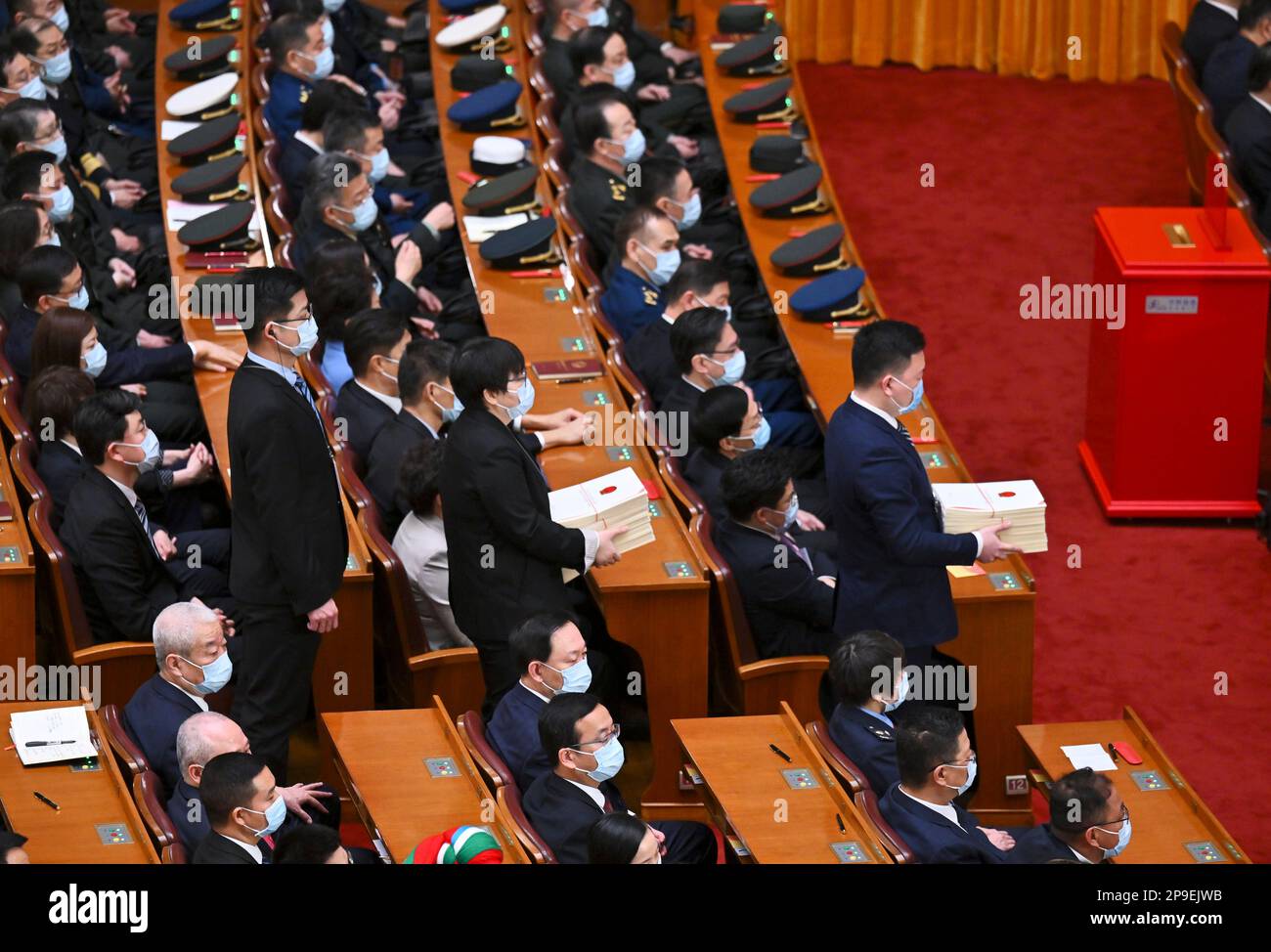 Beijing, China. 11th Mar, 2023. Staff members prepare to distribute ...