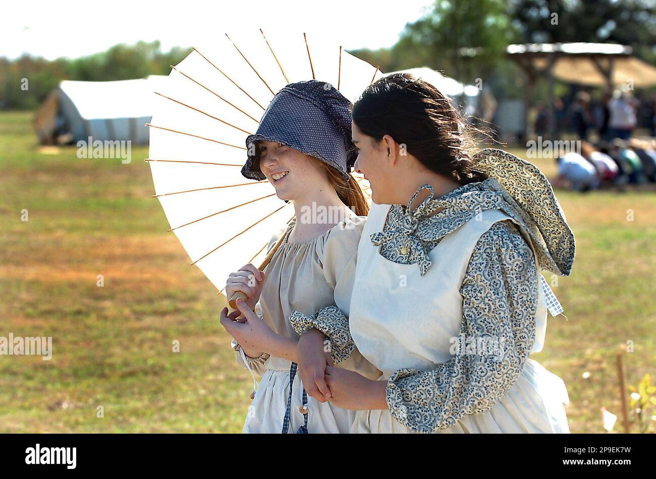 Rachel Paul, left, and Hannah Tidwell, right, stroll arm in arm down a ...