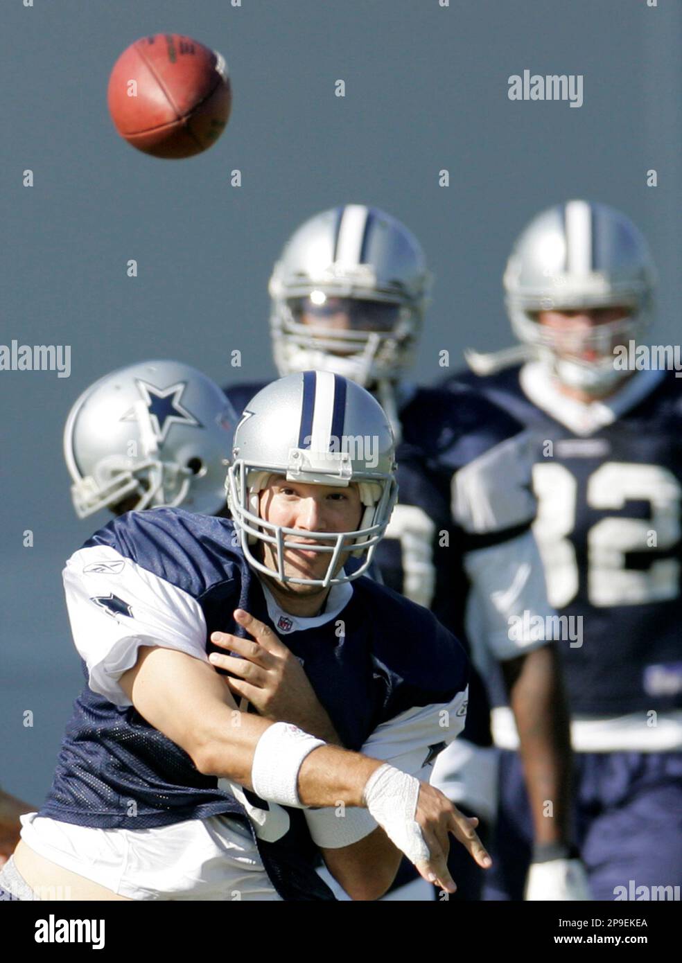 Dallas Cowboys quarterback Tony Romo, front, throws a pass with his ...