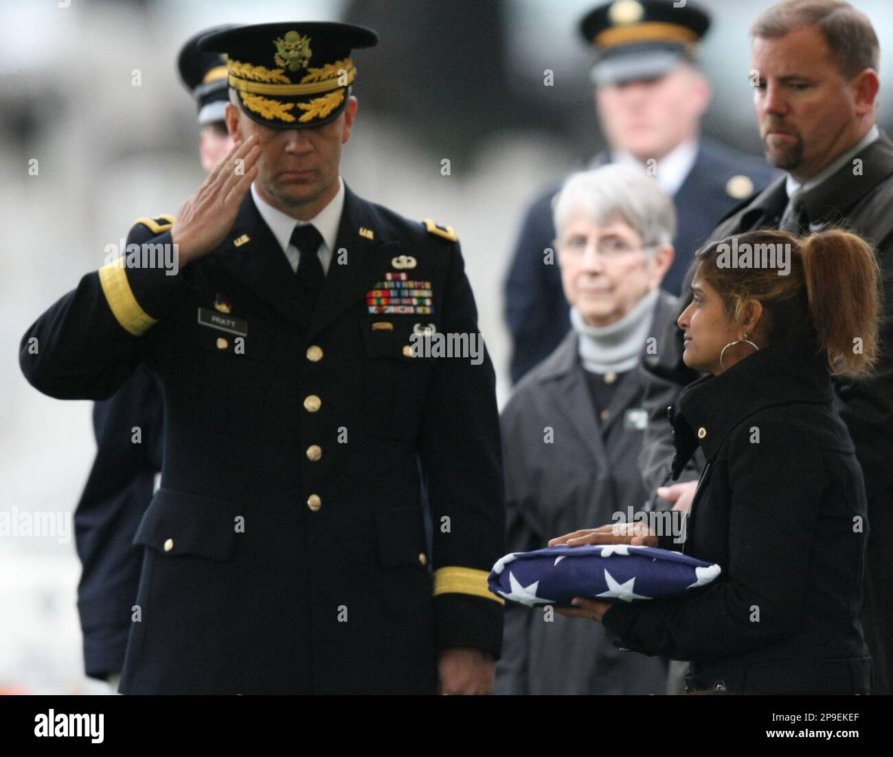 Brig. Gen. Robert Pratt, left, salutes after presenting a flag to ...