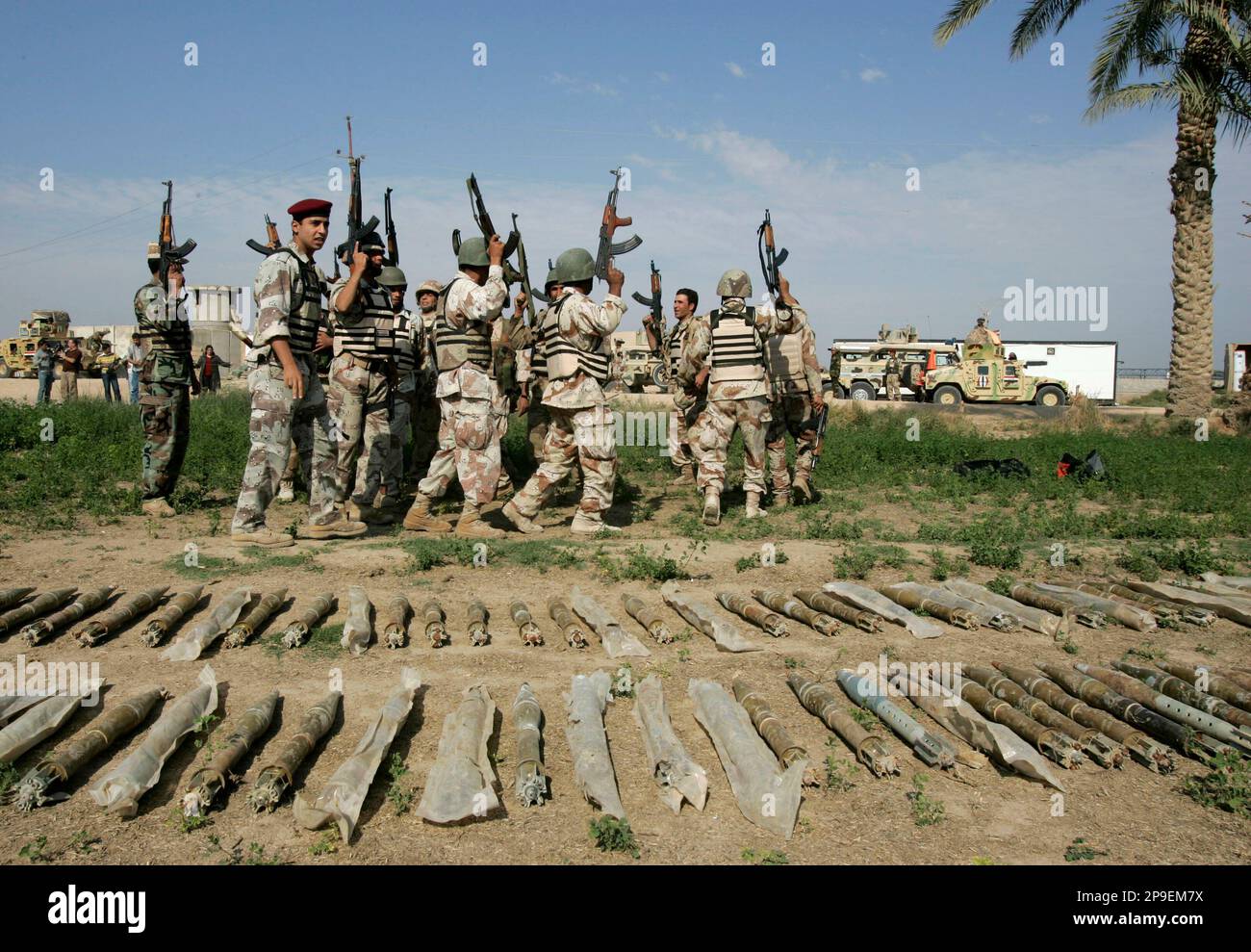 Iraqi Army soldiers celebrate the find of a large weapons cache in ...