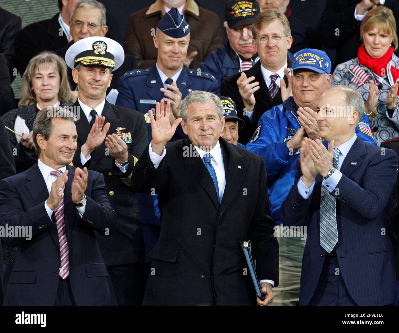 Veterans and their families applaud President Bush, center, at the ...
