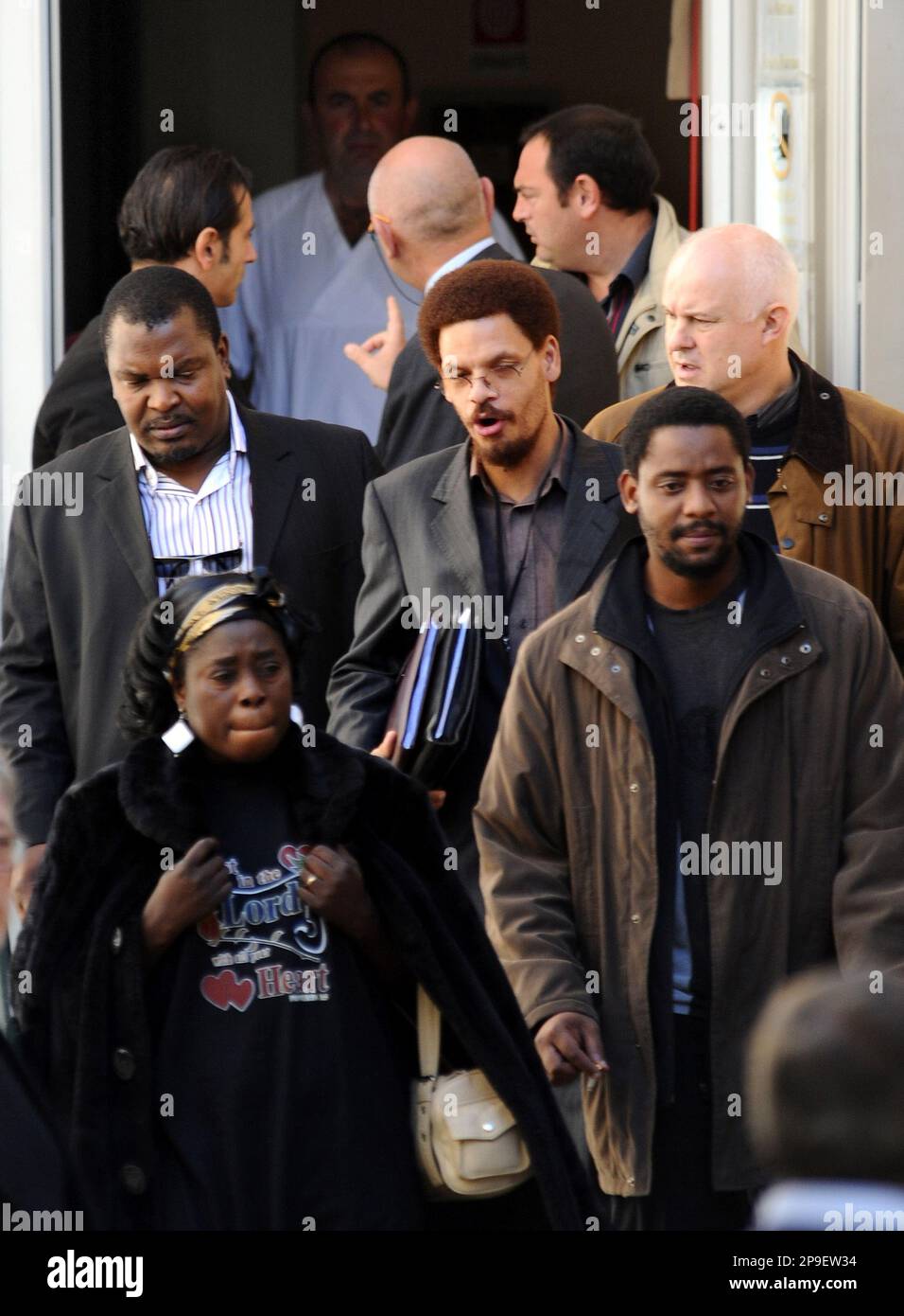 A man identified as Nelson, at center midground with glasses, the ...