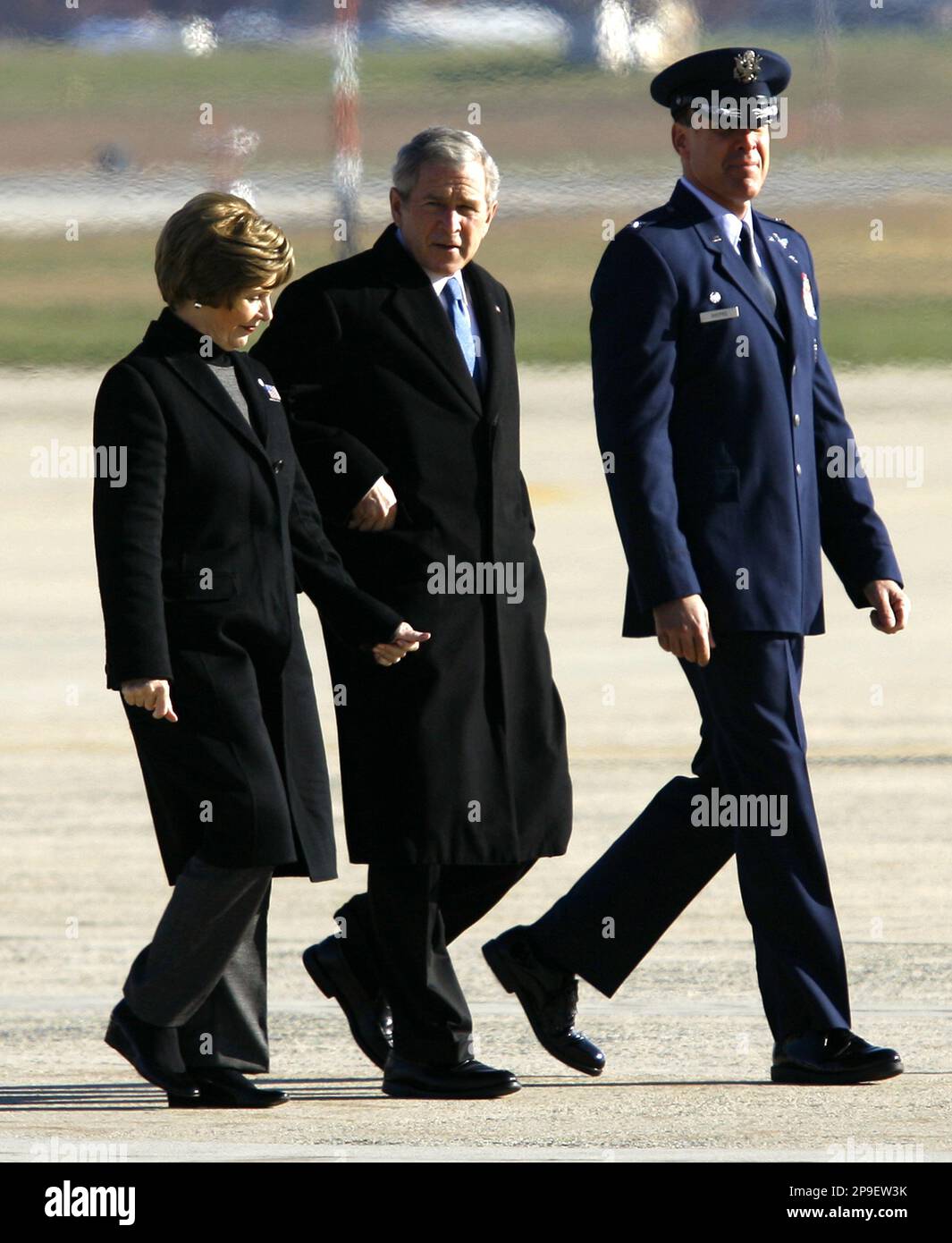 President Bush and first lady Laura Bush walk toward Air Force One at ...