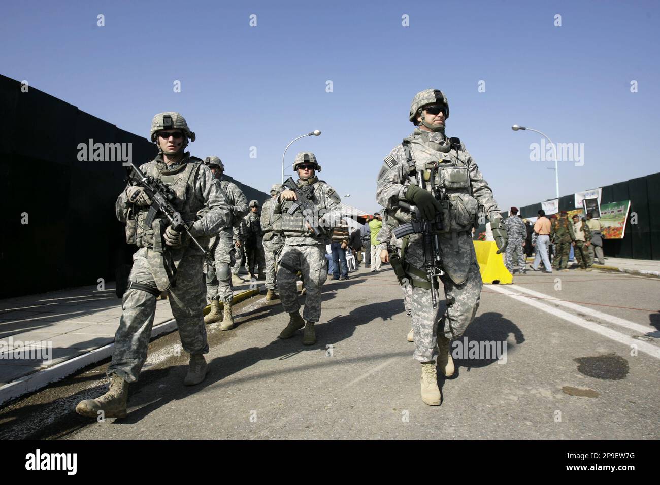 U.S. Army soldiers walk on the Imams Bridge in northern Baghdad, Iraq, Tuesday, Nov. 11, 2008 ...