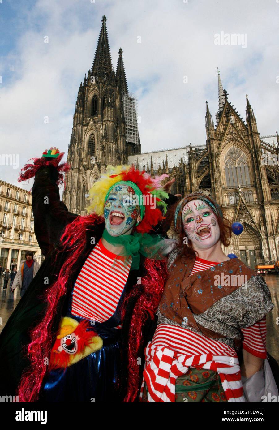 Carnival-goers pose in front of the Cologne Cathedral, Koelner Dom, on ...