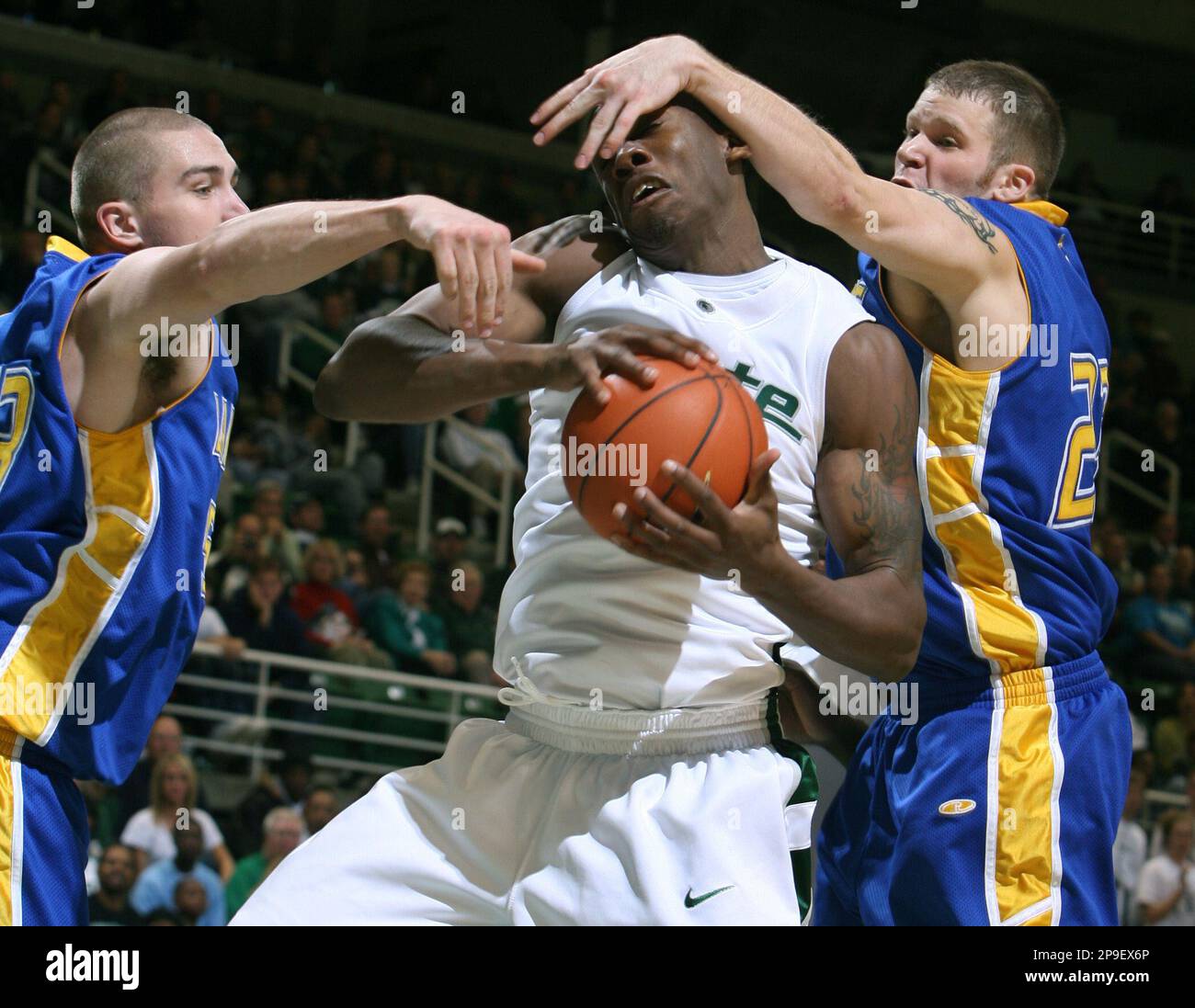 Michigan State's Raymar Morgan, center, is fouled by Lake Superior ...