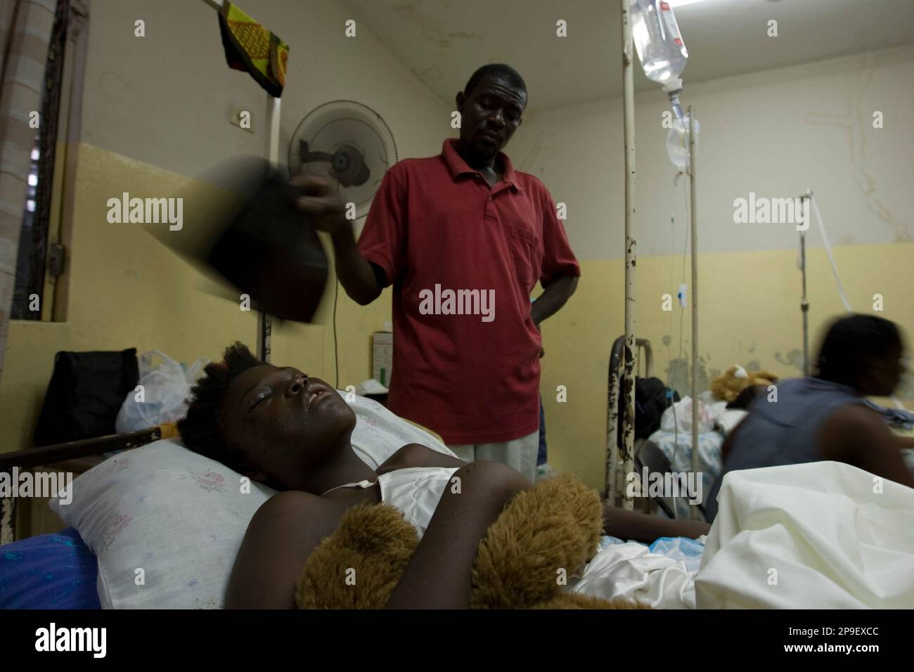 Alfred Fasau, back left, fans his daughter Marienne at the main ...
