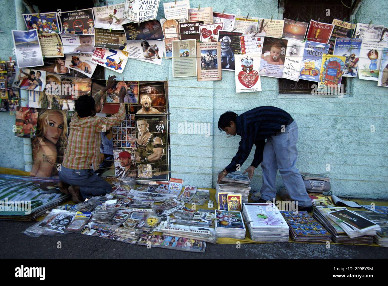 Wayside vendors display posters and pictures of celebrities for sale in ...