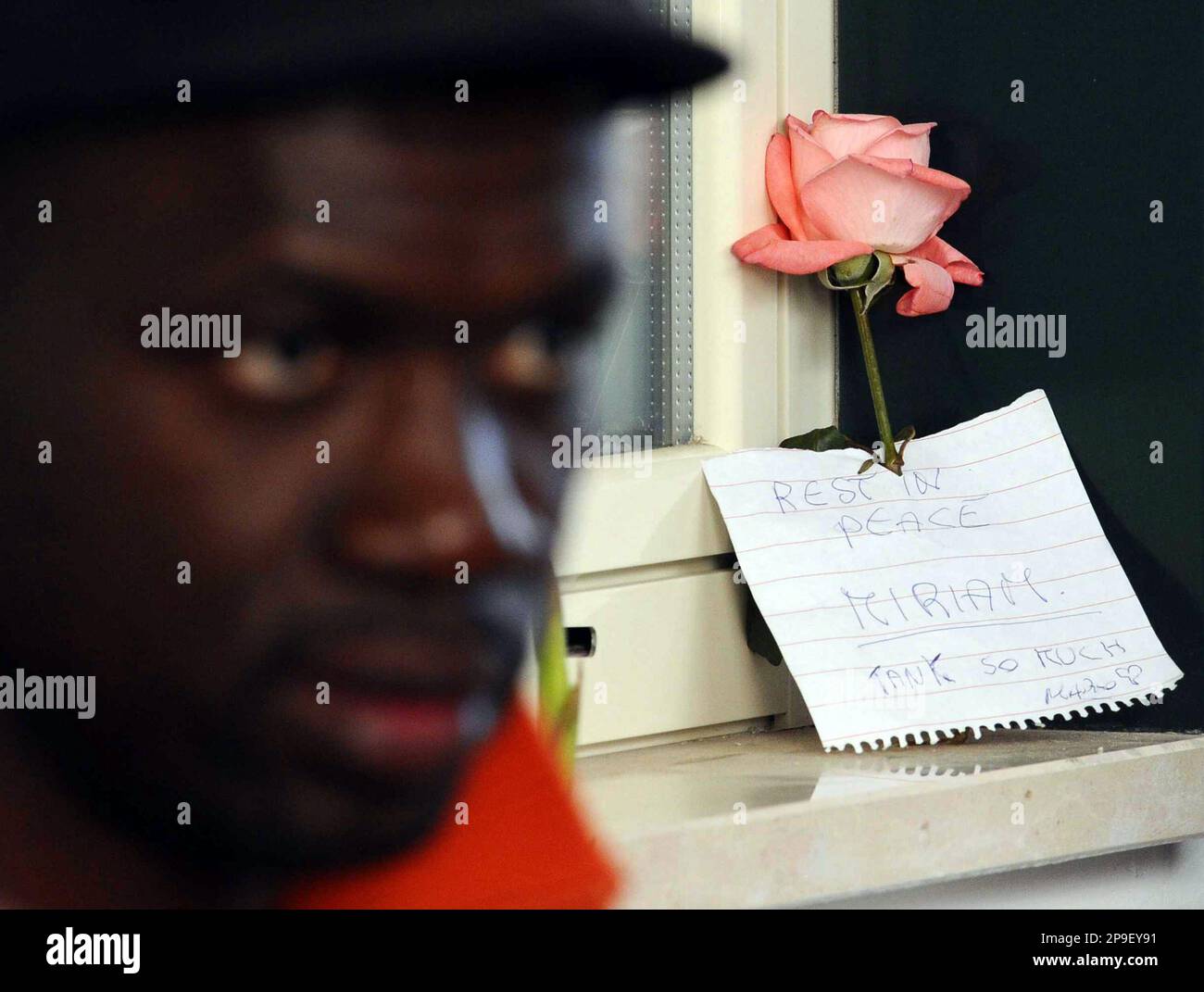 A rose with a signed note saying "REST IN PEACE MIRIAM" with a man ...