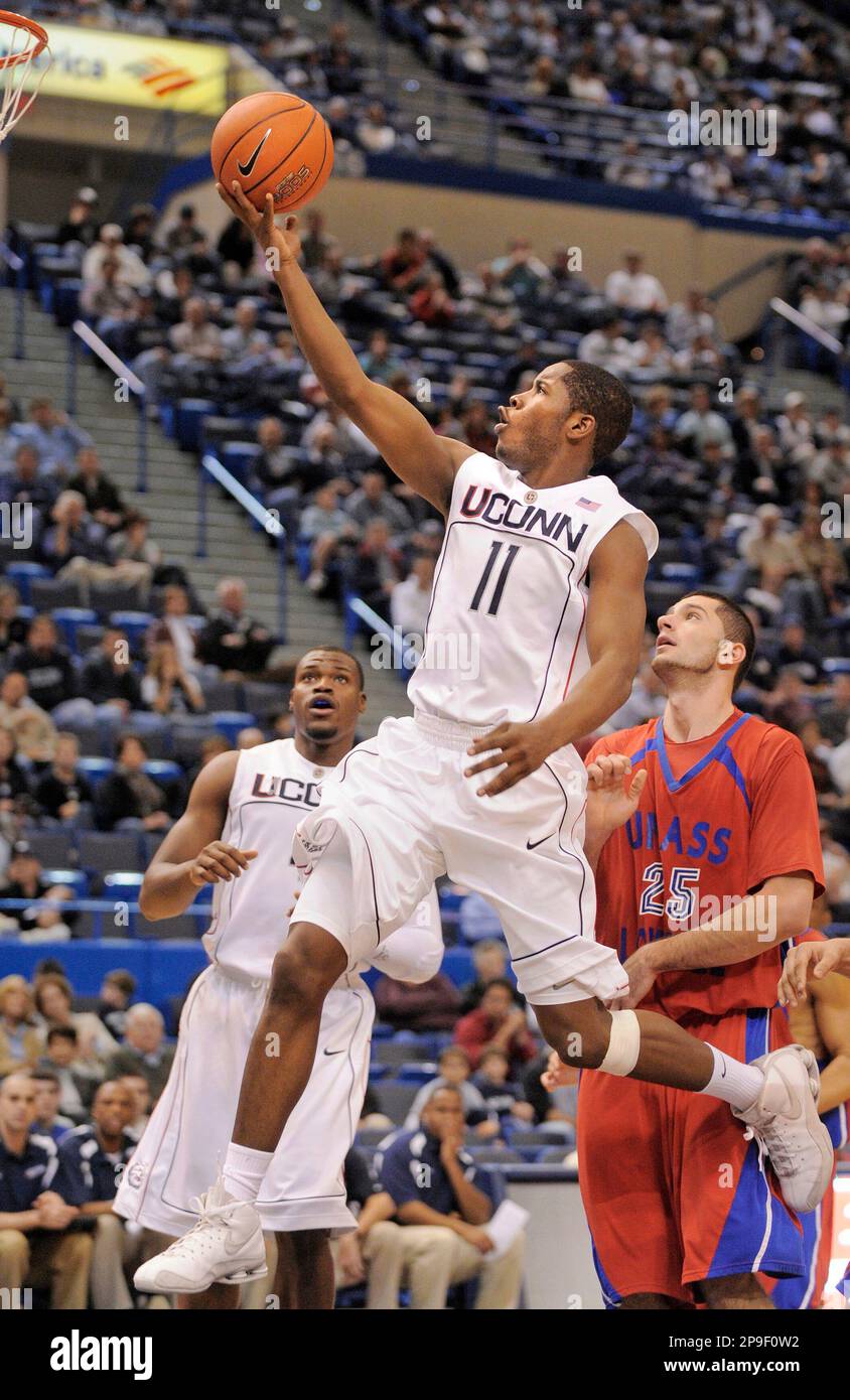 Connecticut's Jerome Dyson (11) scores two of his game-high 18 points ...