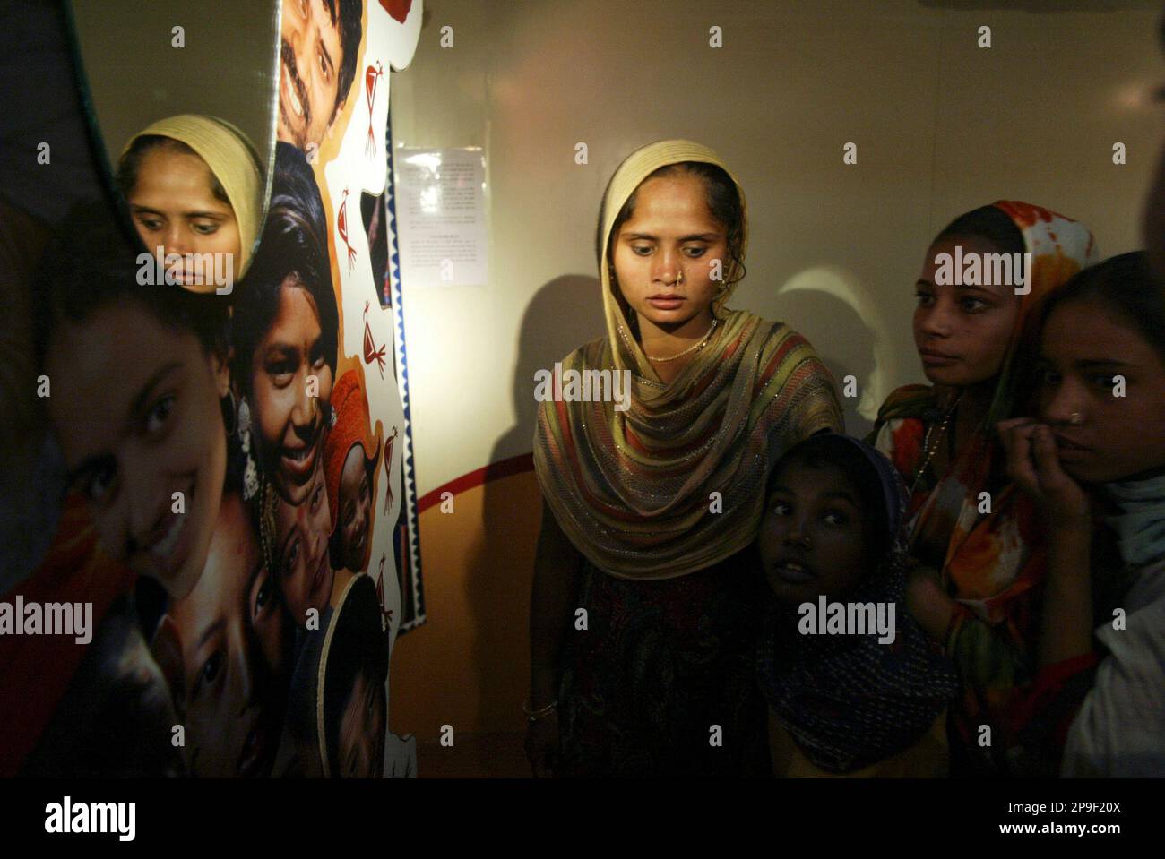 Women from shanty towns look at HIV/AIDS awareness posters inside Red ...