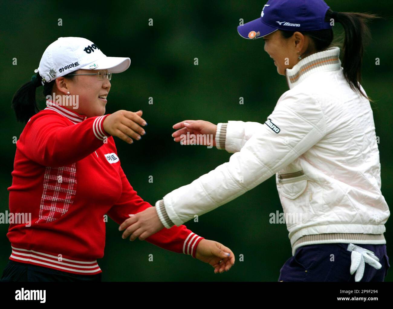 Shin Ji-yai, left, of South Korea and Mayu Hattori of Japan exchange ...
