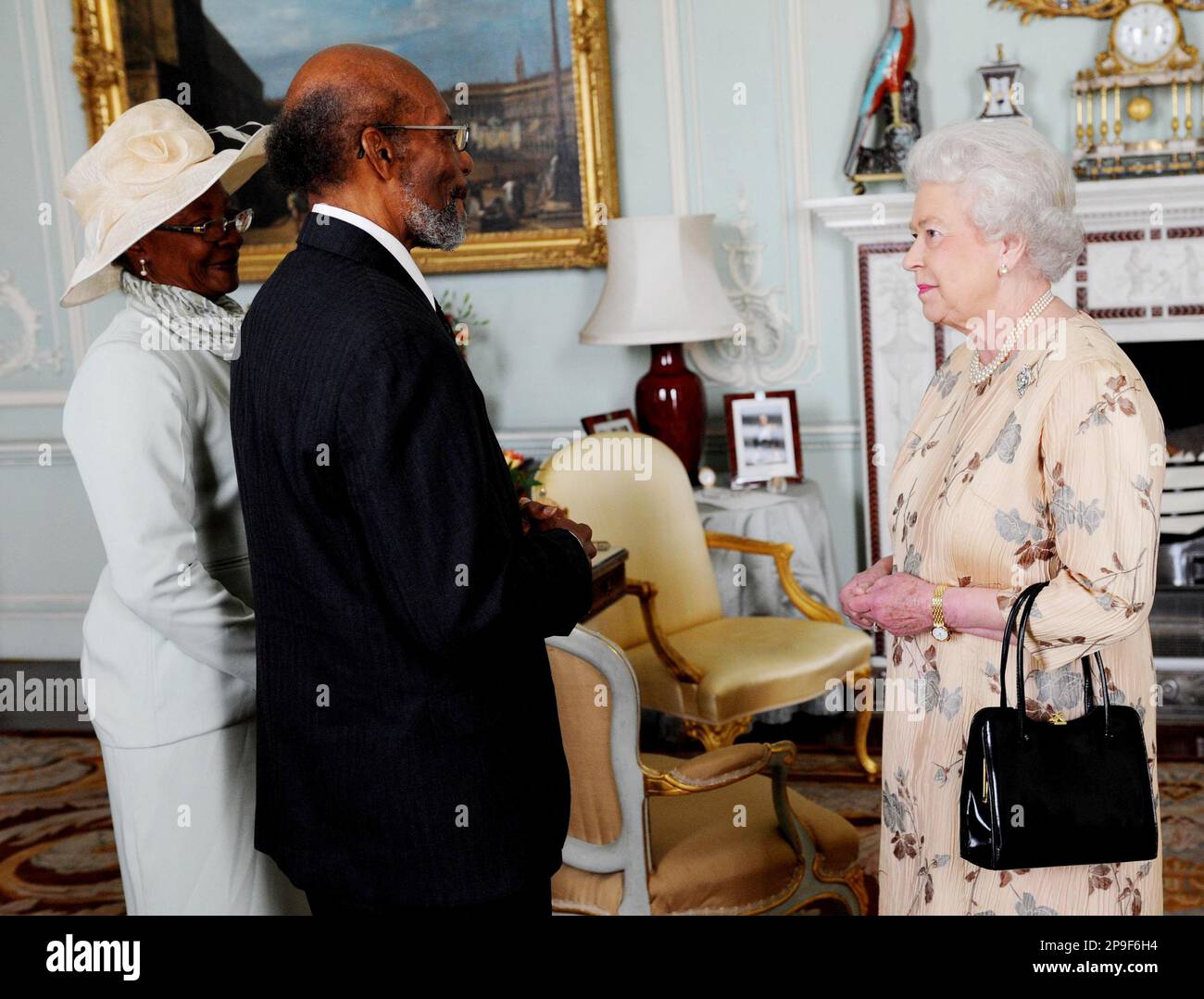 Britain's Queen Elizabeth II receives Sir Daniel Williams on the ...