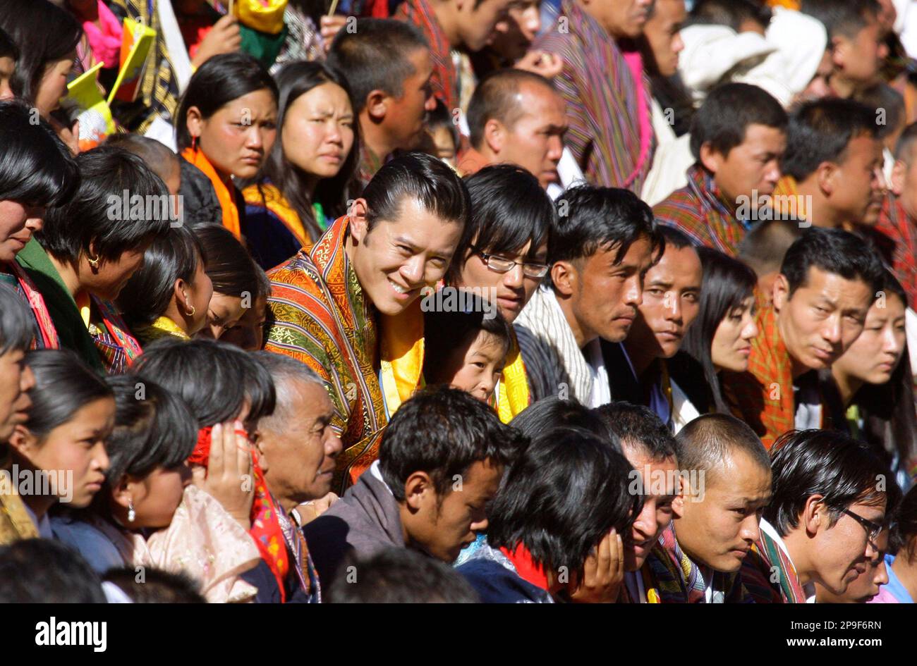 Bhutan's fifth King Jigme Khesar Namgyal Wangchuck, center in yellow ...