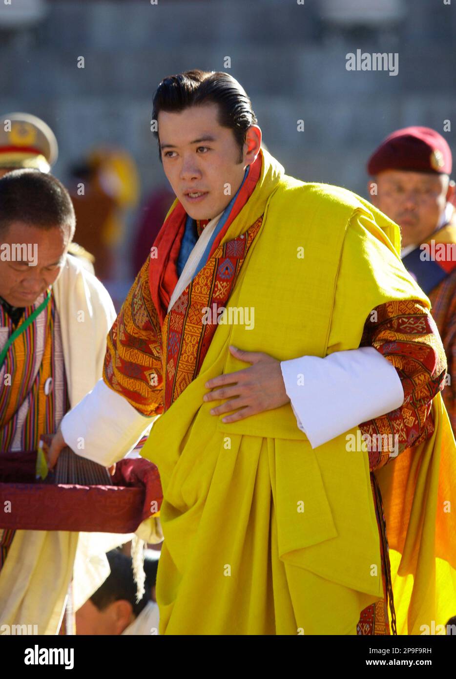 Bhutan's 5th King Jigme Khesar Namgyal Wangchuk, center, picks up ...