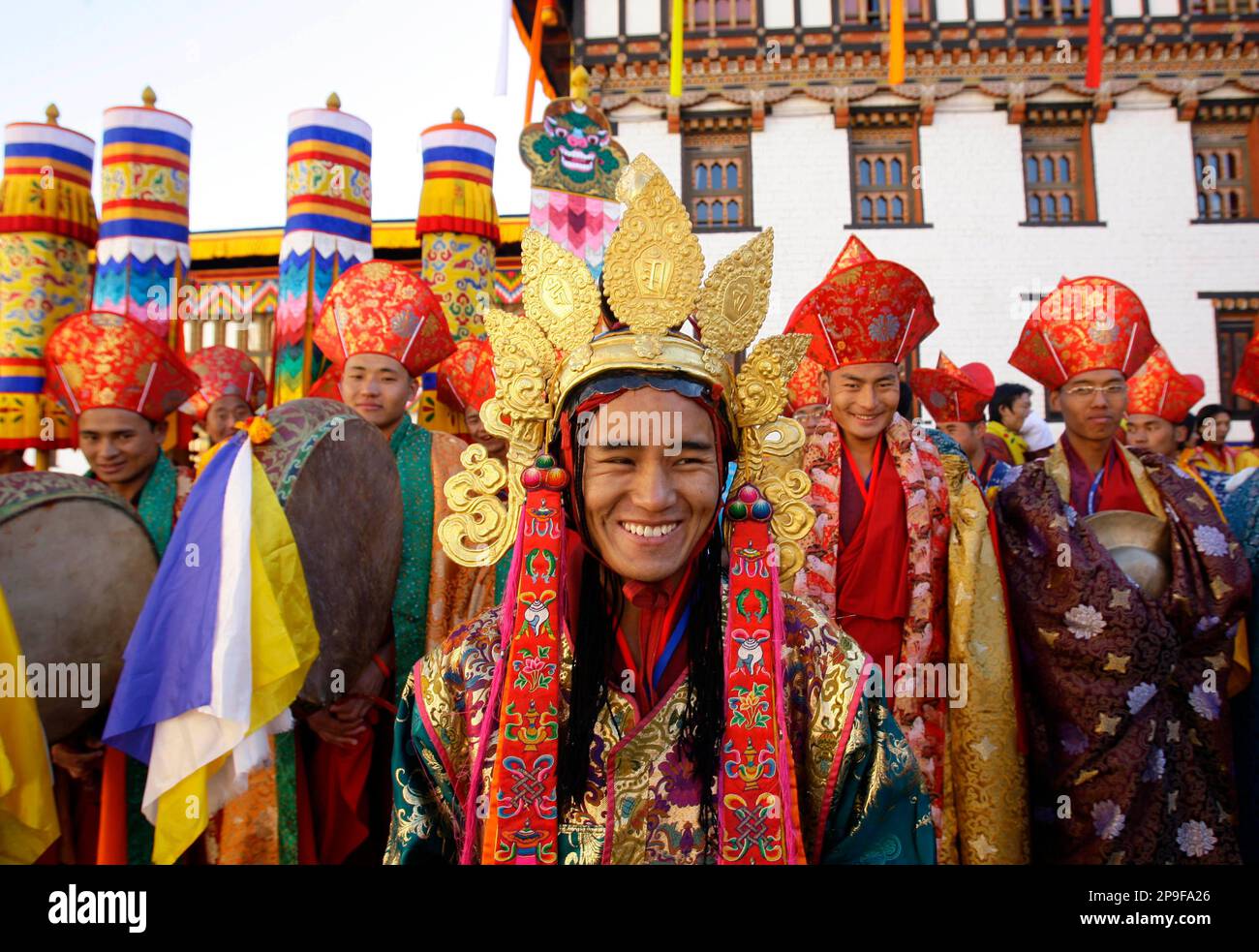 Traditionally attired Bhutanese dancers smile during the coronation ...