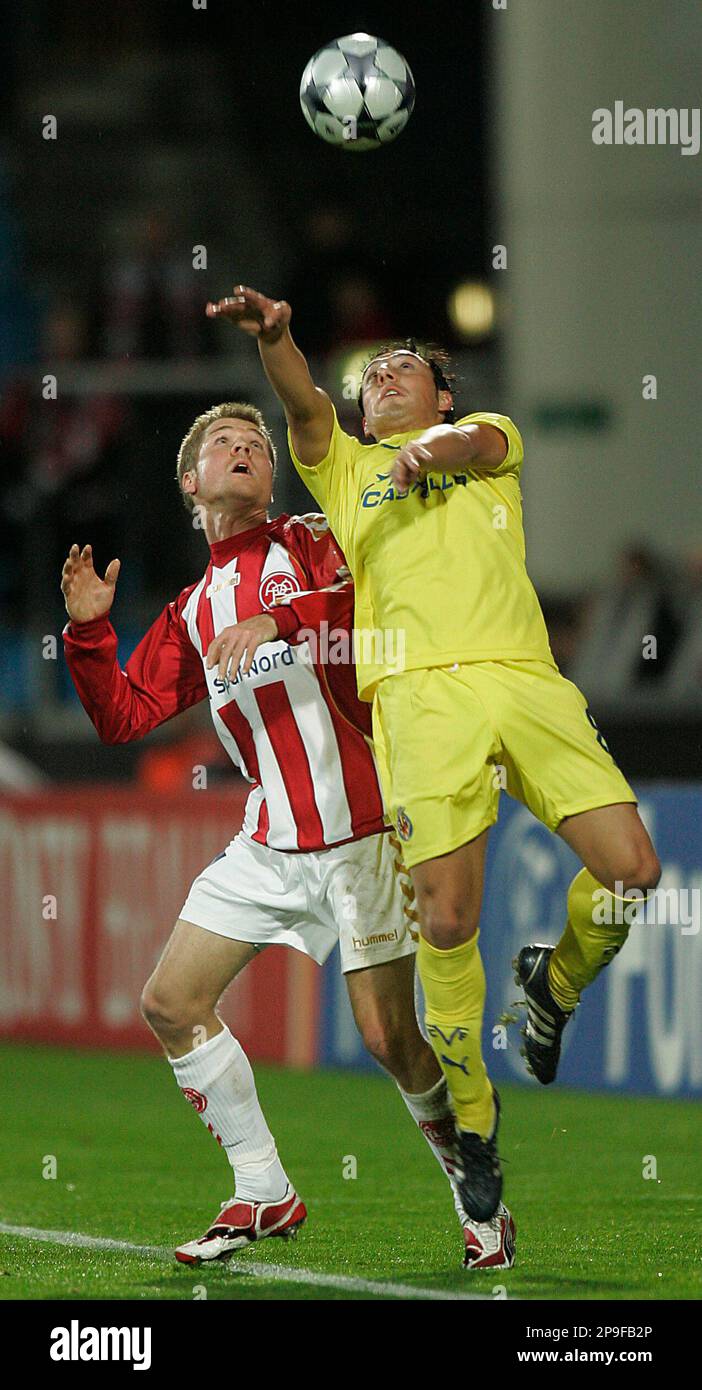 Villareal´s Santi Cazorla, right, heads for the ball with Aalborg´s ...