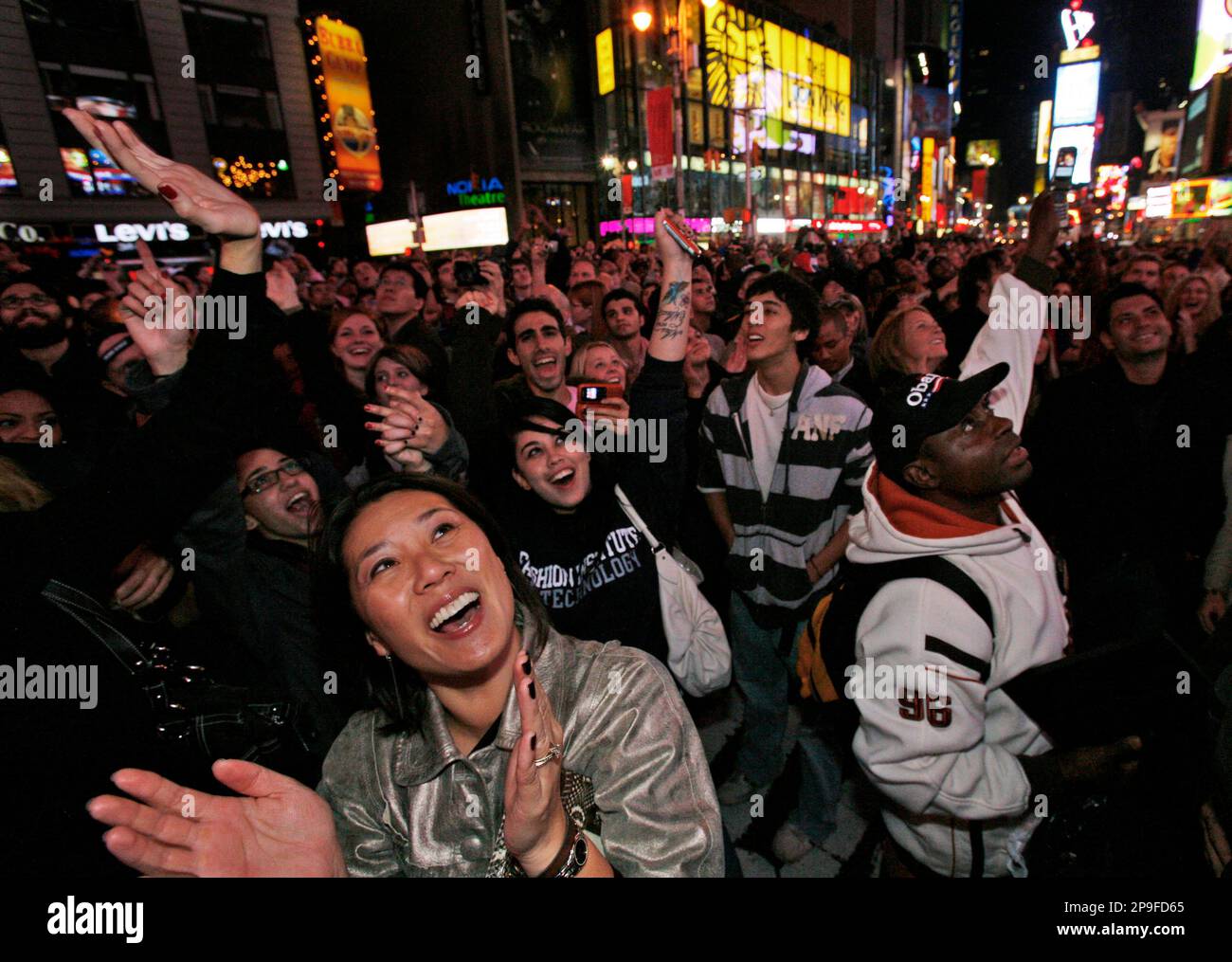 A crowd gathered in Times Square reacts to Barack Obama's acceptance ...