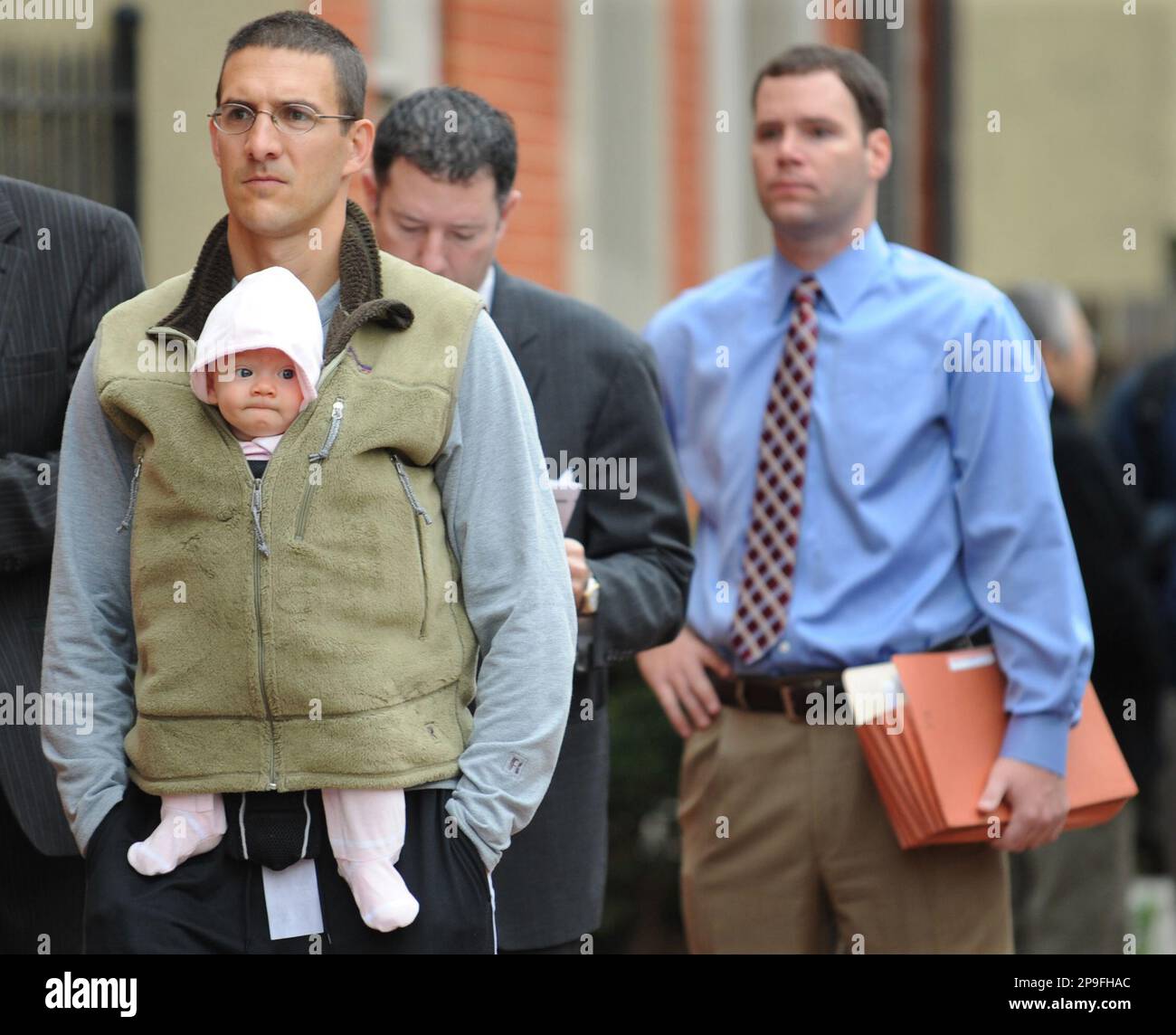 Chris Ketchum and his daughter Isla wait in line to vote Tuesday, Nov ...