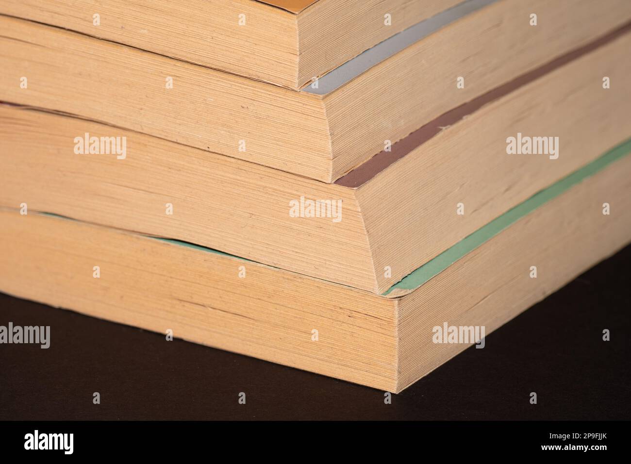 The corner edge of stack of books belonging to a series Stock Photo - Alamy