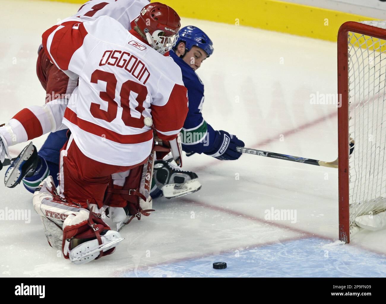 Vancouver Canucks' Kyle Wellwood, right, can't get to the puck after ...