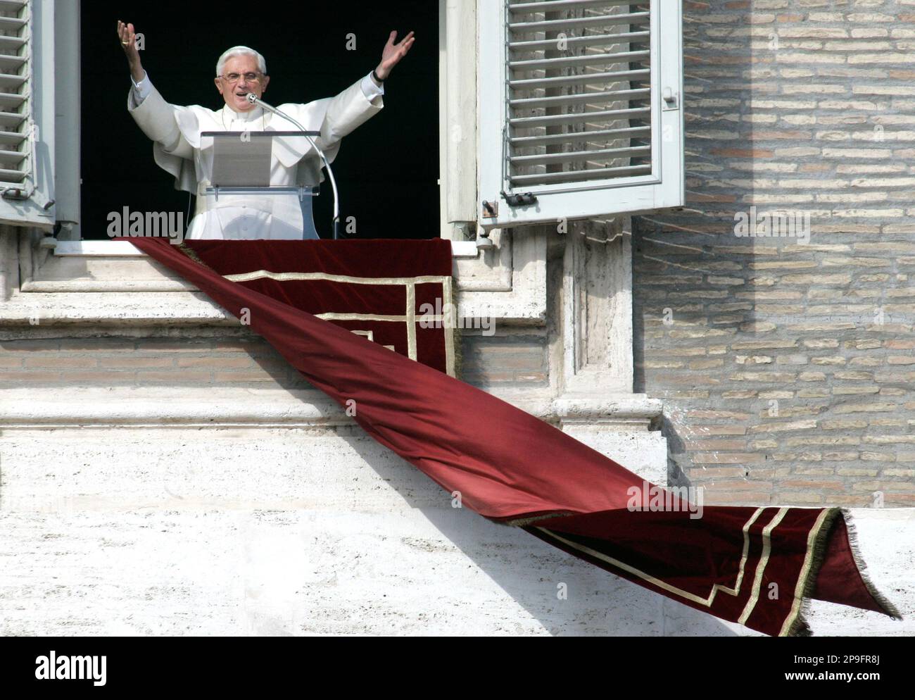 Pope Benedict XVI delivers the Angelus prayer from his studio window ...