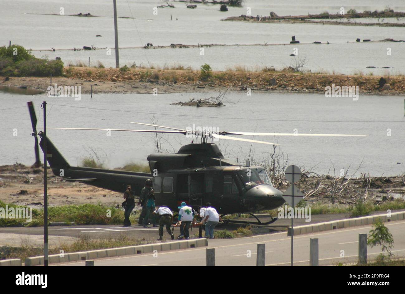 Indonesian rescue members carry a mock victim towards a helicopter ...