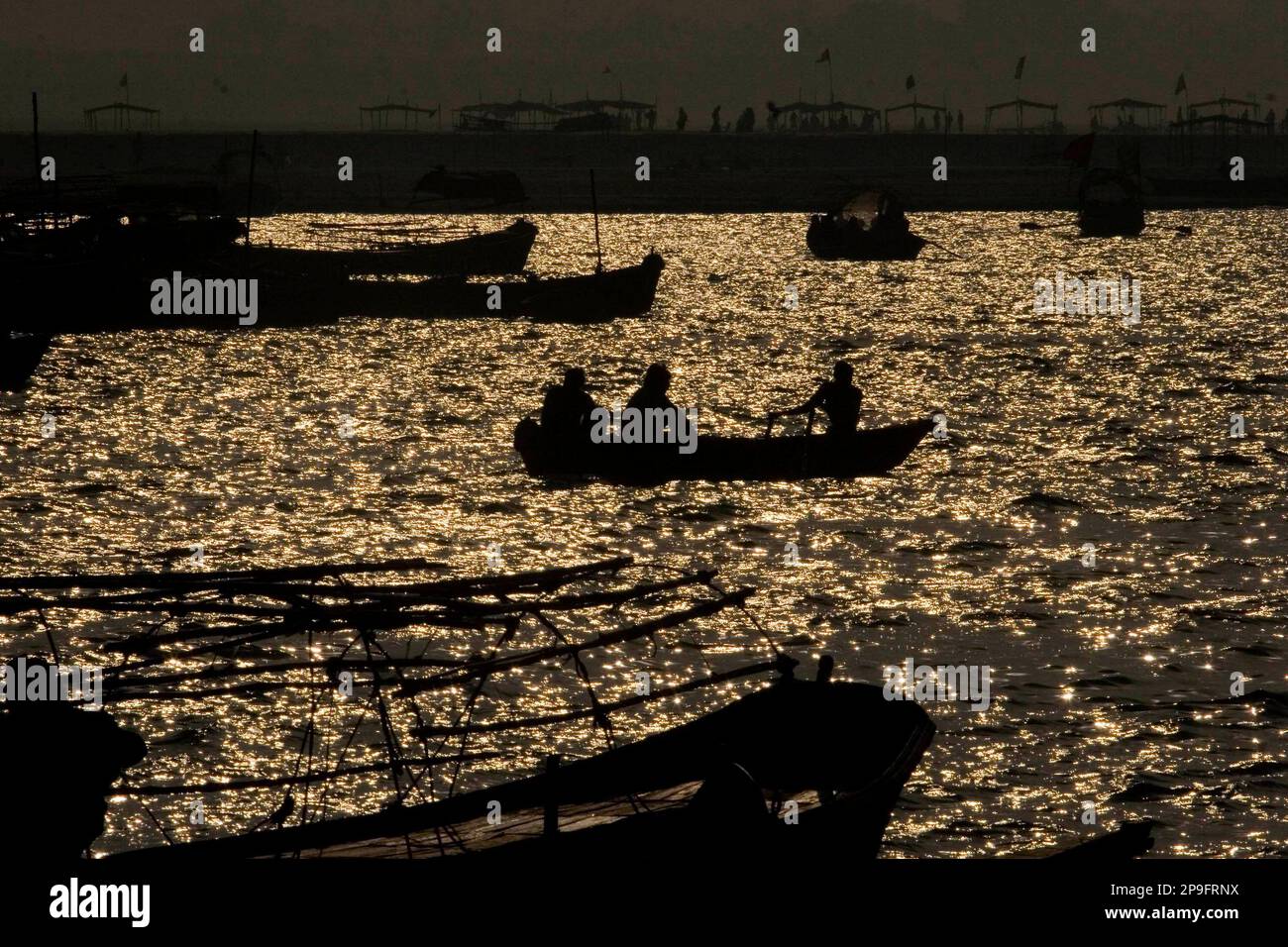 Indian tourists take a boat ride in river Ganges in Allahabad, India ...