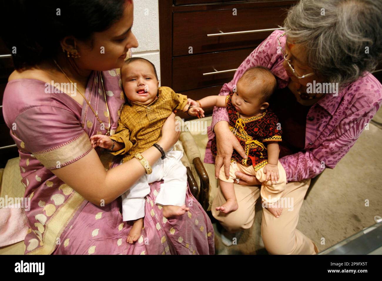 Three-month old baby girl, Manji, on right, born to an Indian surrogate ...