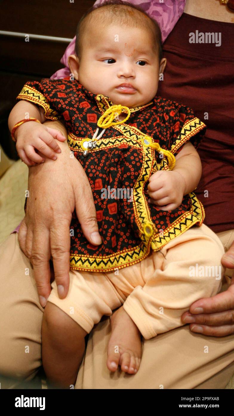 A three-month old baby girl, Manji, born to an Indian surrogate mother ...
