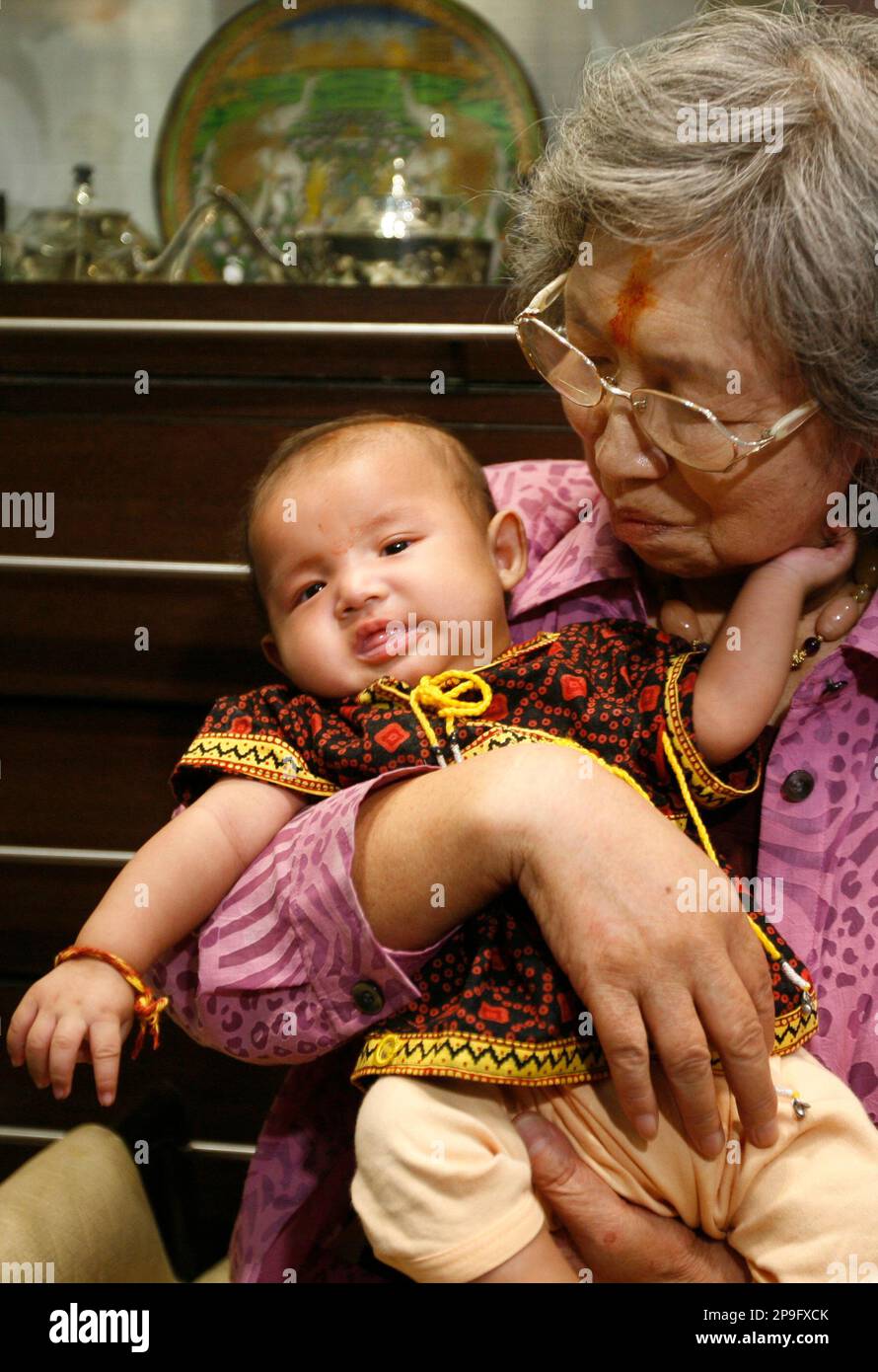 A three-month old baby girl, Manji, born to an Indian surrogate mother ...