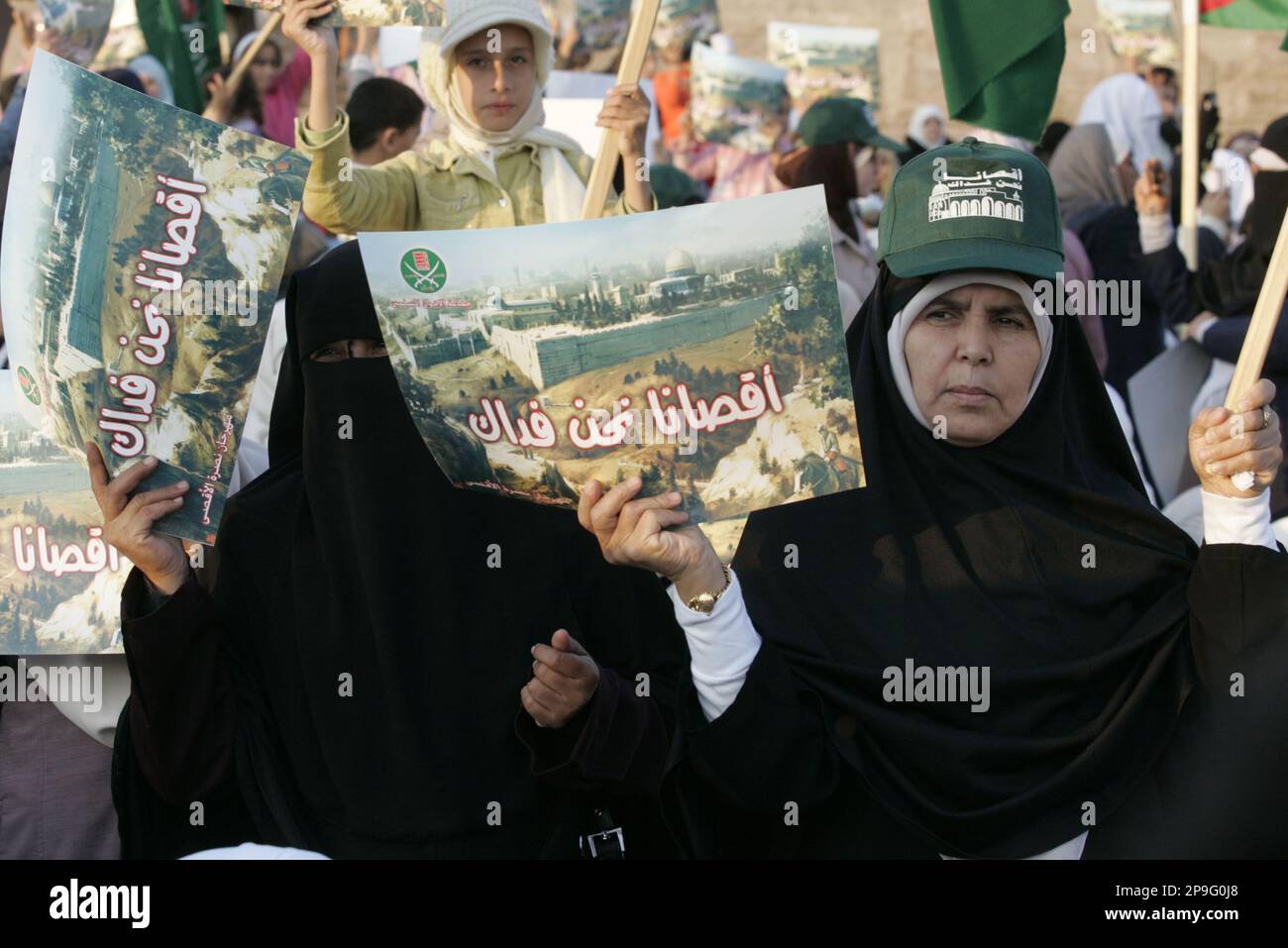 Jordanian Muslim women holds pictures of Al-Aqsa Mosque, during a rally ...